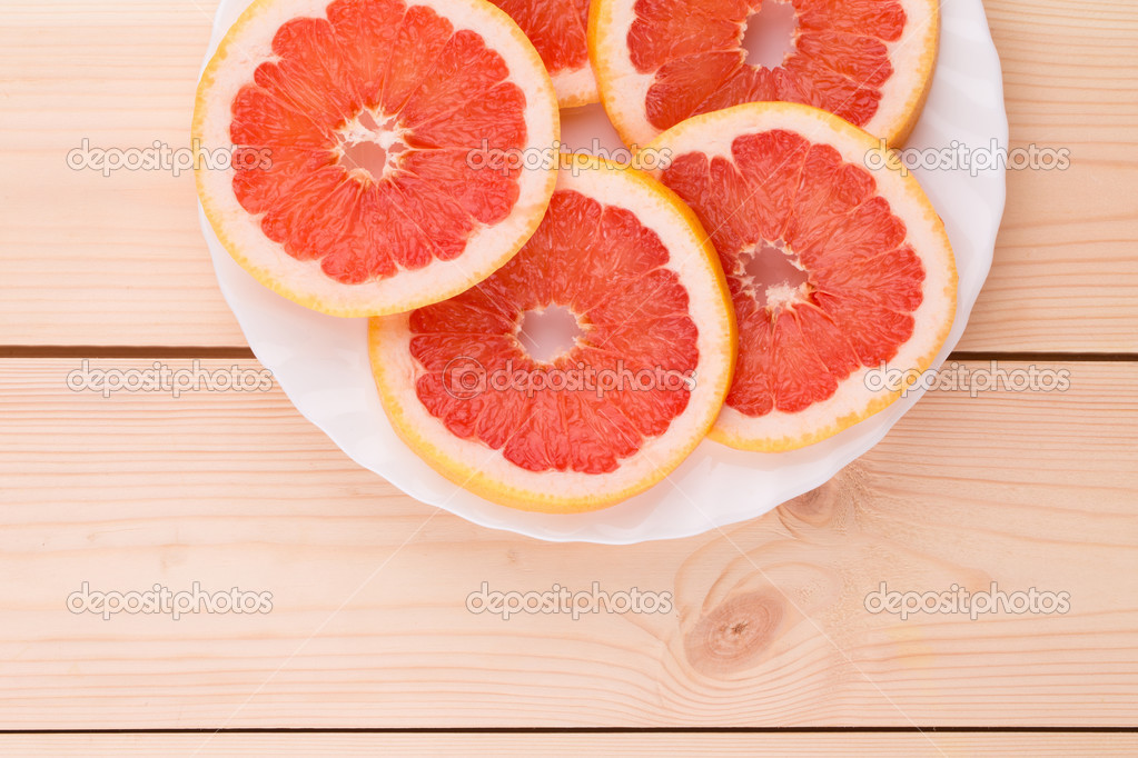 Portion of sliced grapefruit on plate. — Stock Photo © indigolotos ...