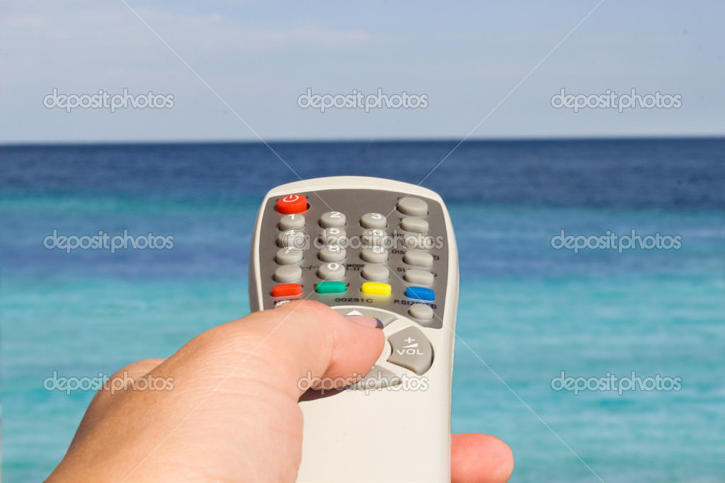 Someone holding a remote control on the background of the sea Stock ...