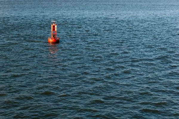 Red buoy floating on rippled water Stock Photo by ©MrHamster 113545600
