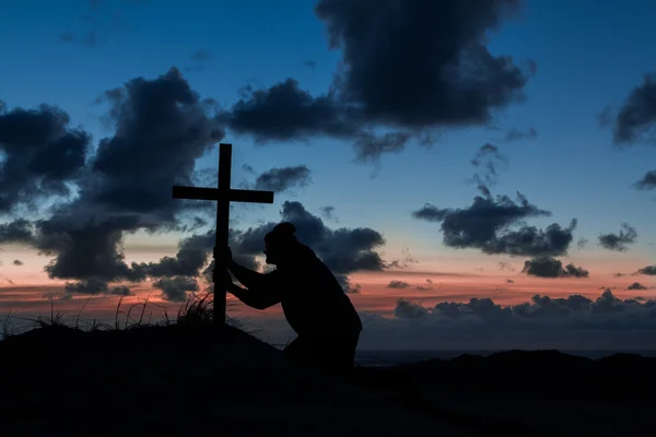 Man kneeling at the cross Stock Photos, Royalty Free Man kneeling at ...
