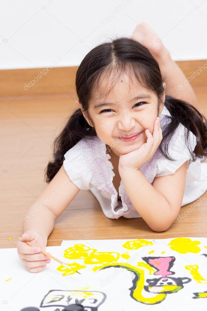 Little Asian child drawing on paper — Stock Photo © chomnancoffee #32100487