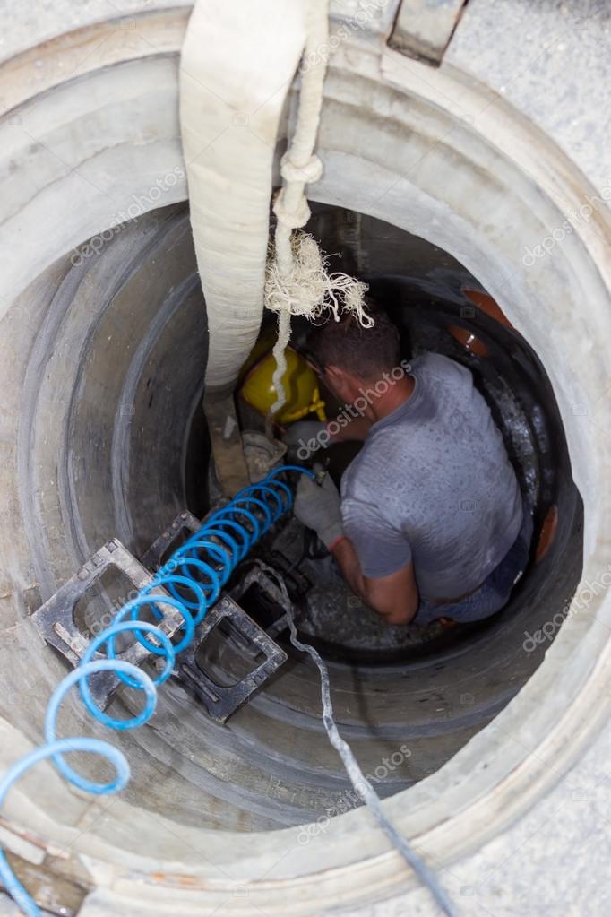 Worker inside a manhole - working in a manhole — Stock Photo ...