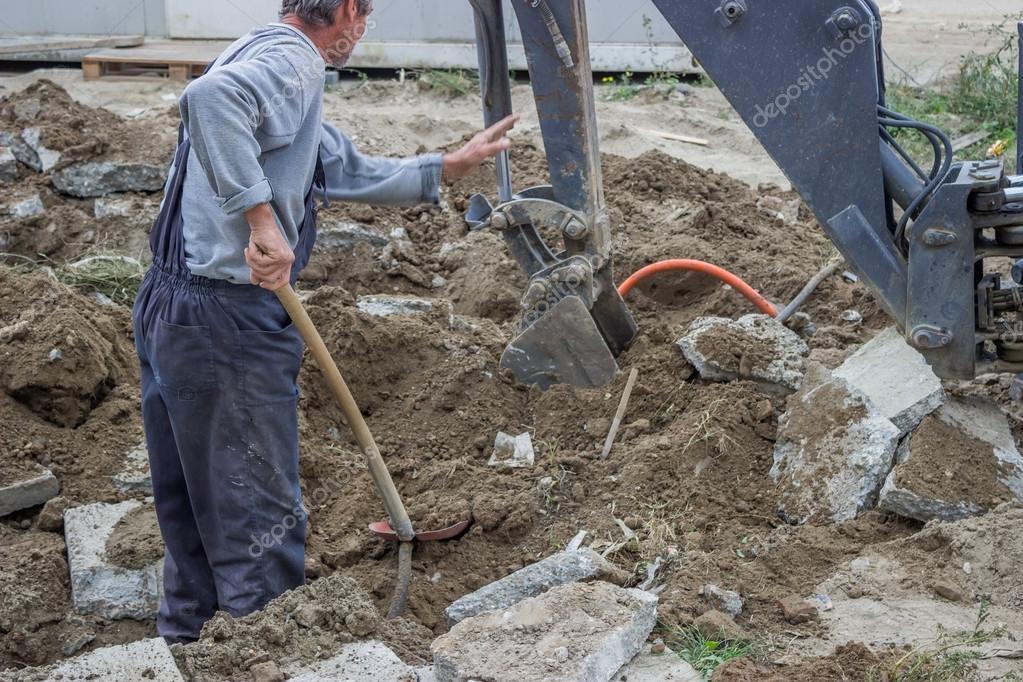 Worker and mini excavator arm digging up a electrical cables 3 — Stock ...