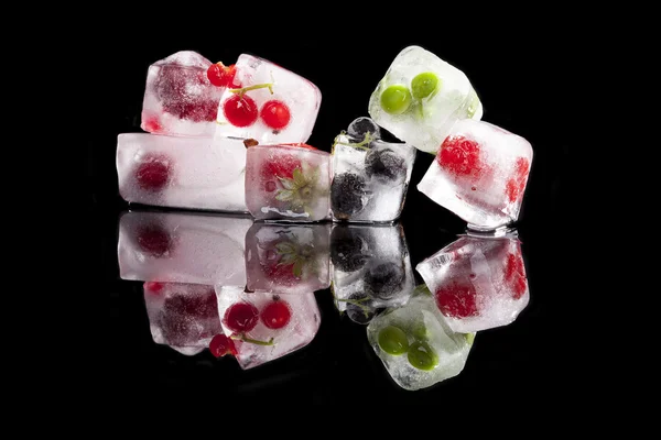 Berries frozen in ice cubes. Stock Photo by ©eskymaks 52630145