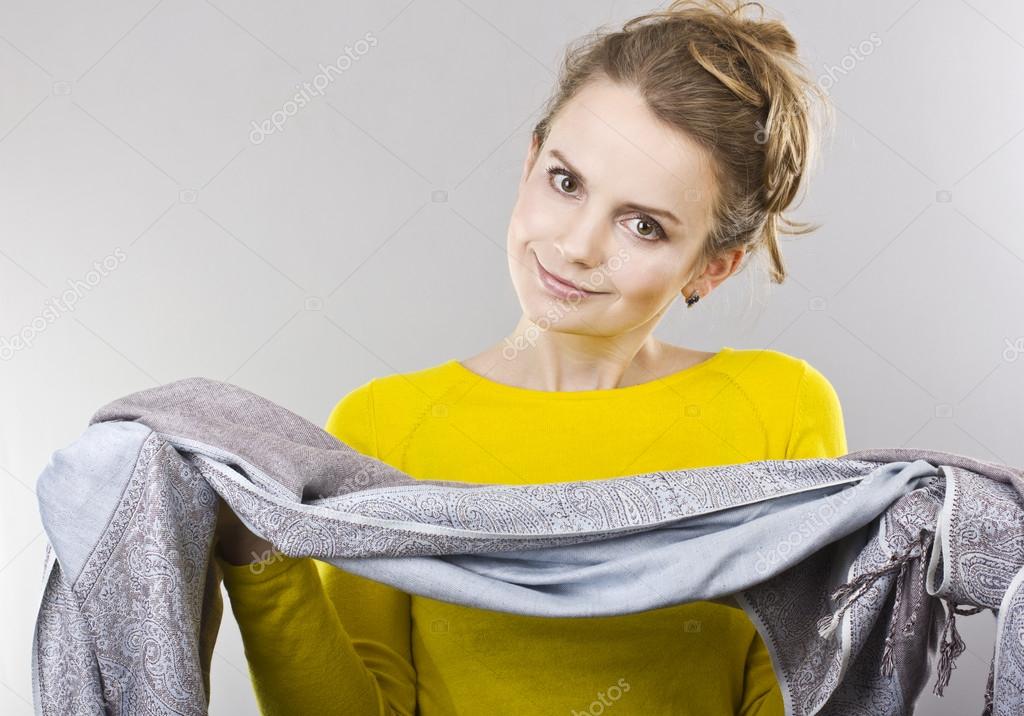 Young blonde with clothes in hands — Stock Photo © rubchikovaa #45937041