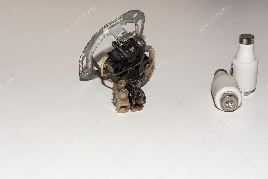 Damaged electrical socket with a pair of fuses — Stock Photo © anze ...