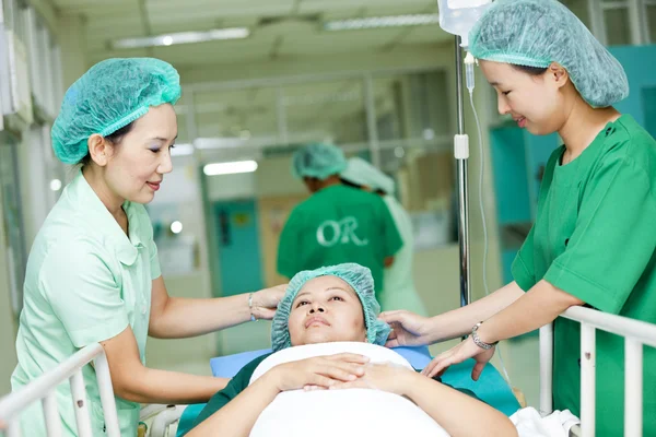 Workers moving patient to operating room - Stock Image - Everypixel