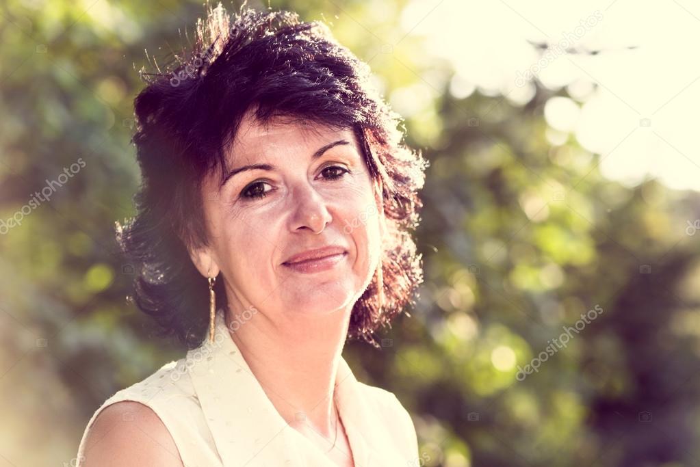 Woman in her 50s smiling outdoors portrait Stock Photo by ©nadinasa ...