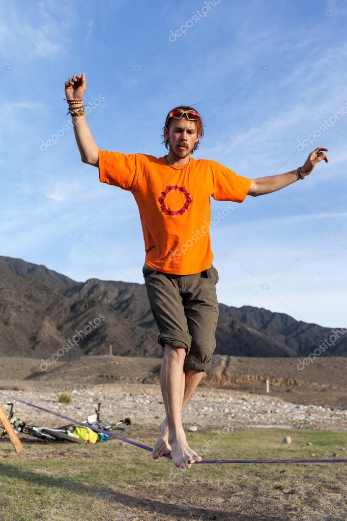 Man walking on the sling at sunset Stock Photo by ©Wassiliy 46763021