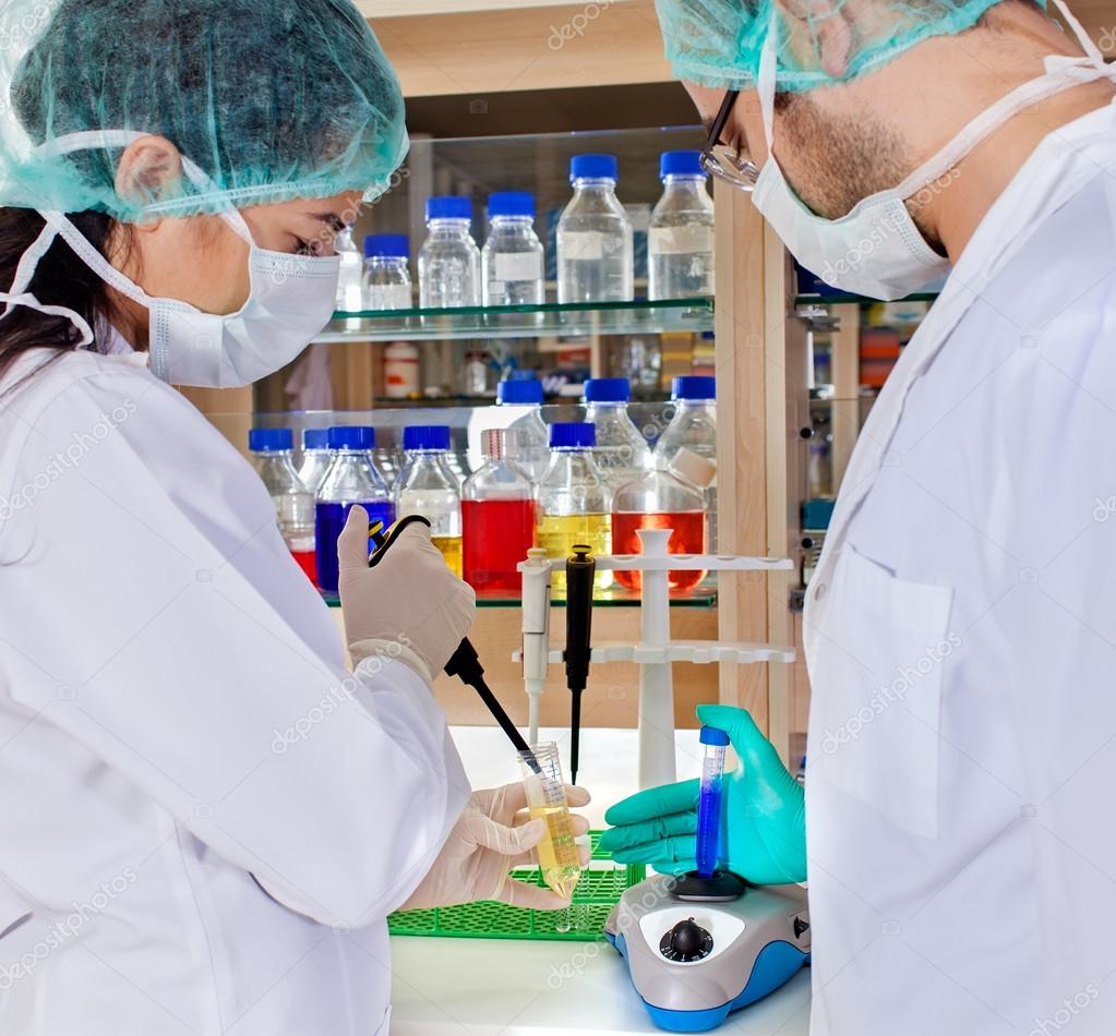 Two laboratory technicians conducting a test. — Stock Photo © belahoche ... Two laboratory technicians conducting a test. — Stock Photo © belahoche ...