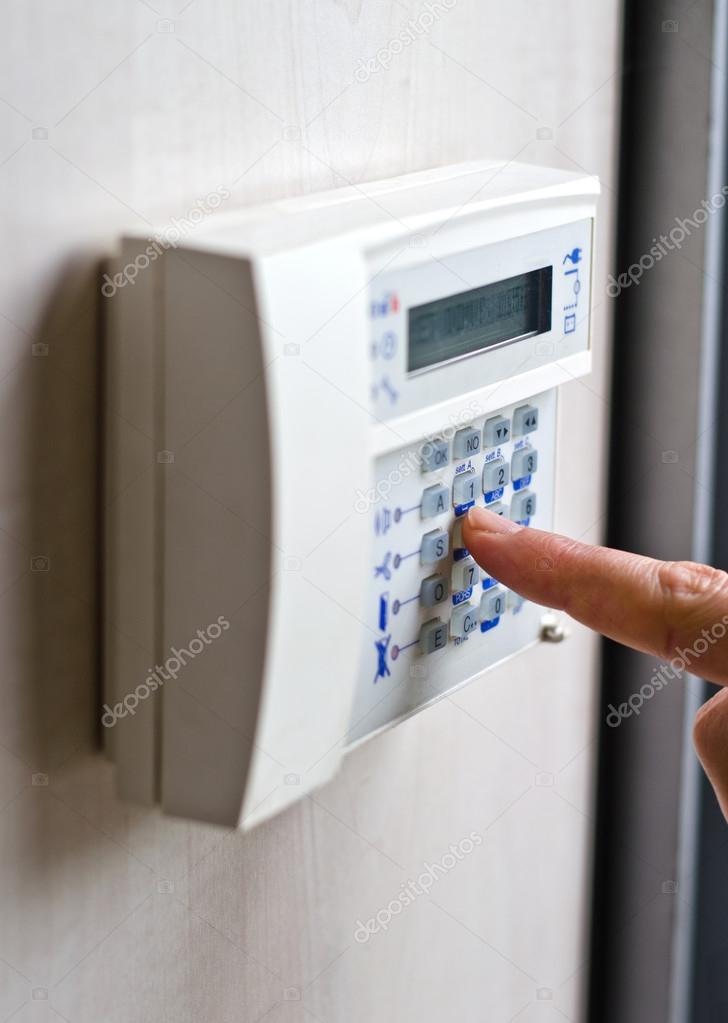Finger pressing keys on alarm keypad — Stock Photo © StarsStudio #33364551