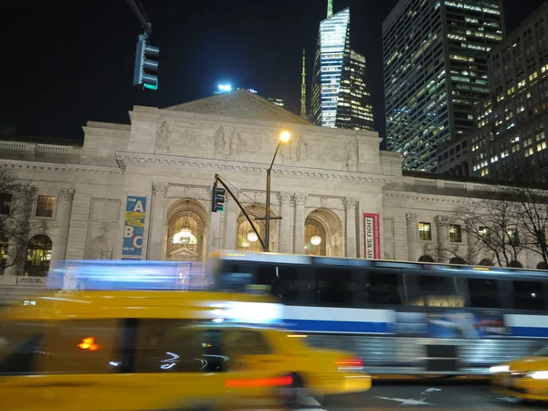 New York Public Library with busy traffic going by at night - Stock ...