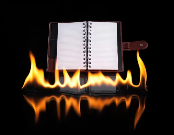 notebook in fire flame on black background - Stock Image - Everypixel