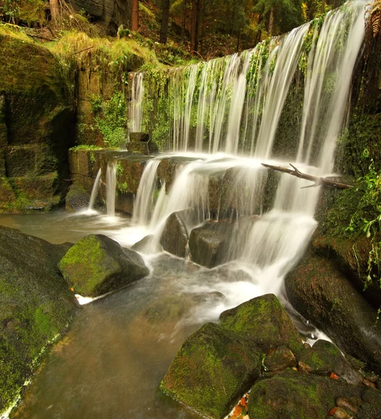 Cascade of small weir on mountain stream, water is running over ...