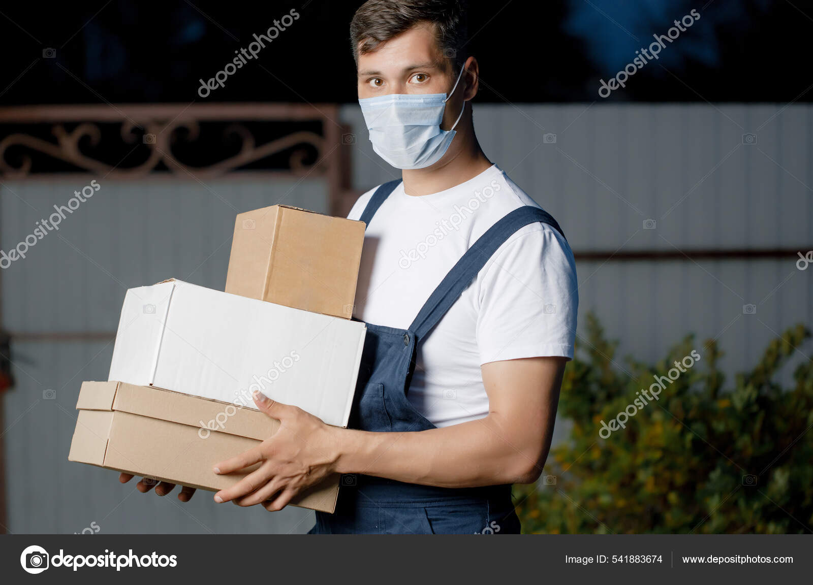 Handsome Young Man Uniform Mask Delivers Package Man Holds Stack Stock ...
