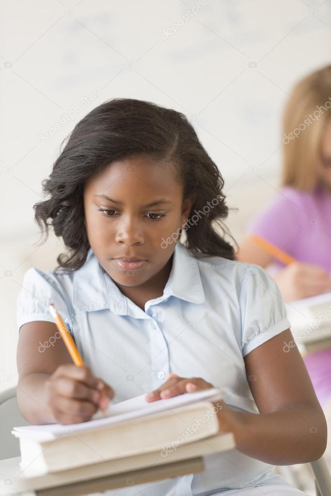 Girl Writing Notes At Classroom Stock Photo by ©tmcphotos 32774223