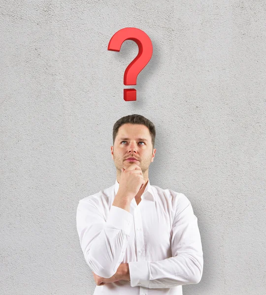 Portrait of a young man with green question mark above his head ...