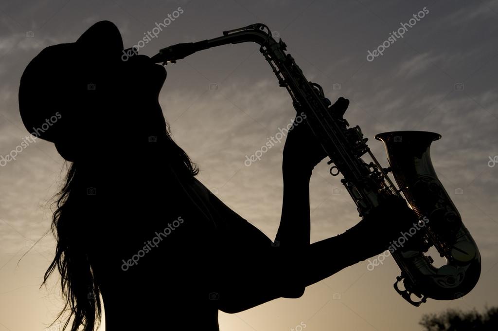 Silhouette of a woman playing saxophone — Stock Photo © JoseTandem ...