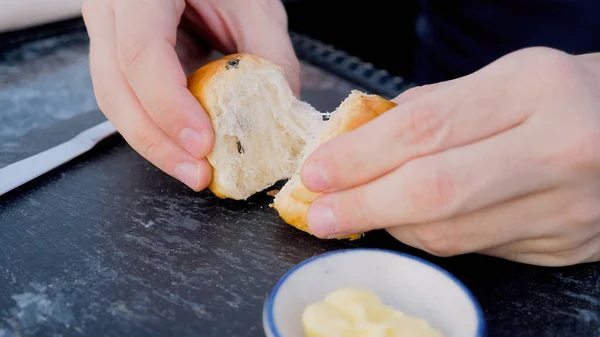 Male baker hands breaking homemade bread into two parts. Man chef hands ...