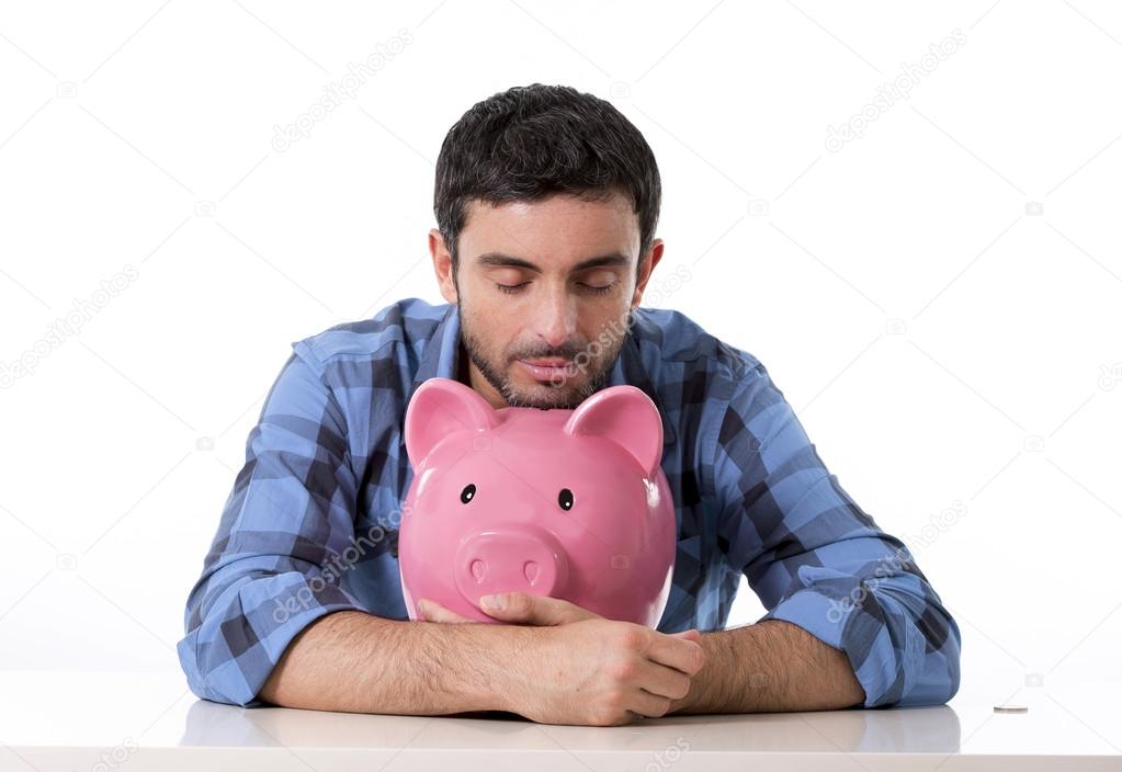 Sad worried man in stress with piggy bank in bad financial situation ...