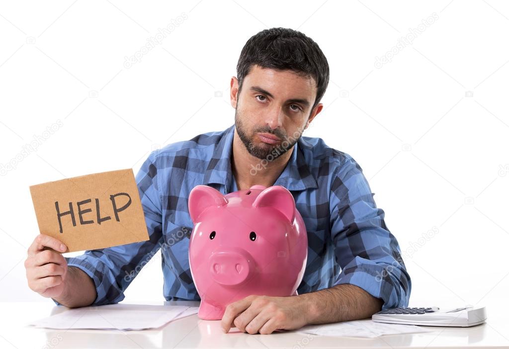 Sad worried man in stress with piggy bank in bad financial situation ...
