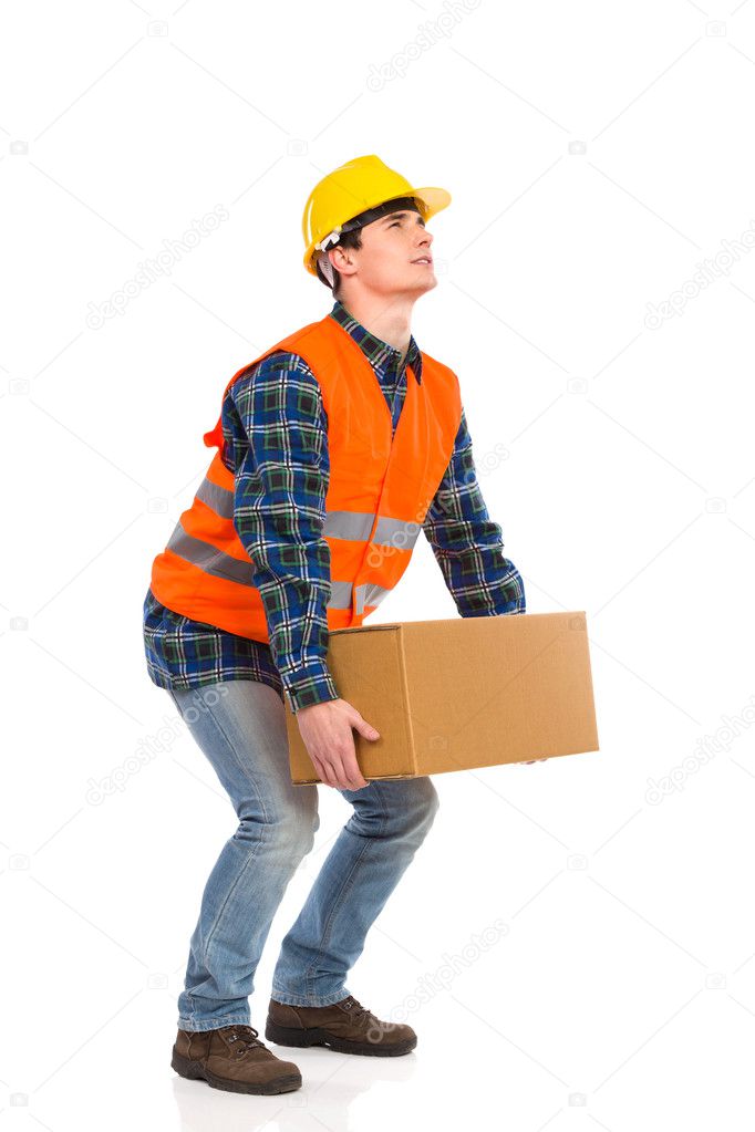 Construction worker picking up heavy box. — Stock Photo © studioloco ...