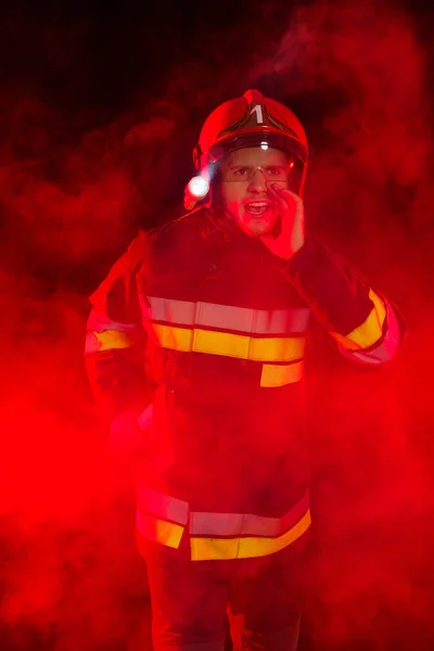 Shouting fireman in smoke. - Stock Image - Everypixel