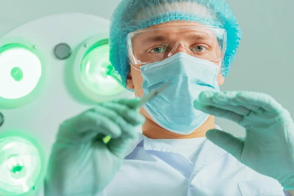 Physician surgeon with a scalpel Stock Photo by ©Remains 45501087