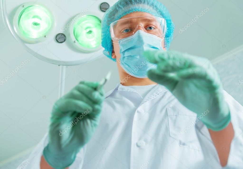 Physician surgeon with a scalpel Stock Photo by ©Remains 45501087