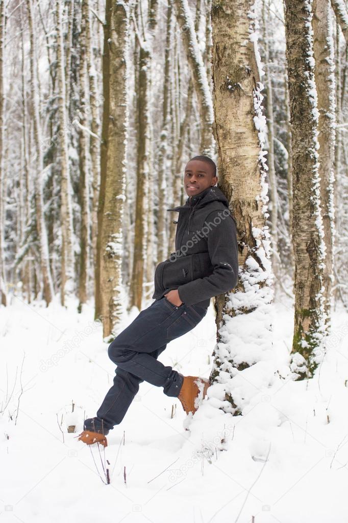 Black man in the snow against a tree ⬇ Stock Photo, Image by ...