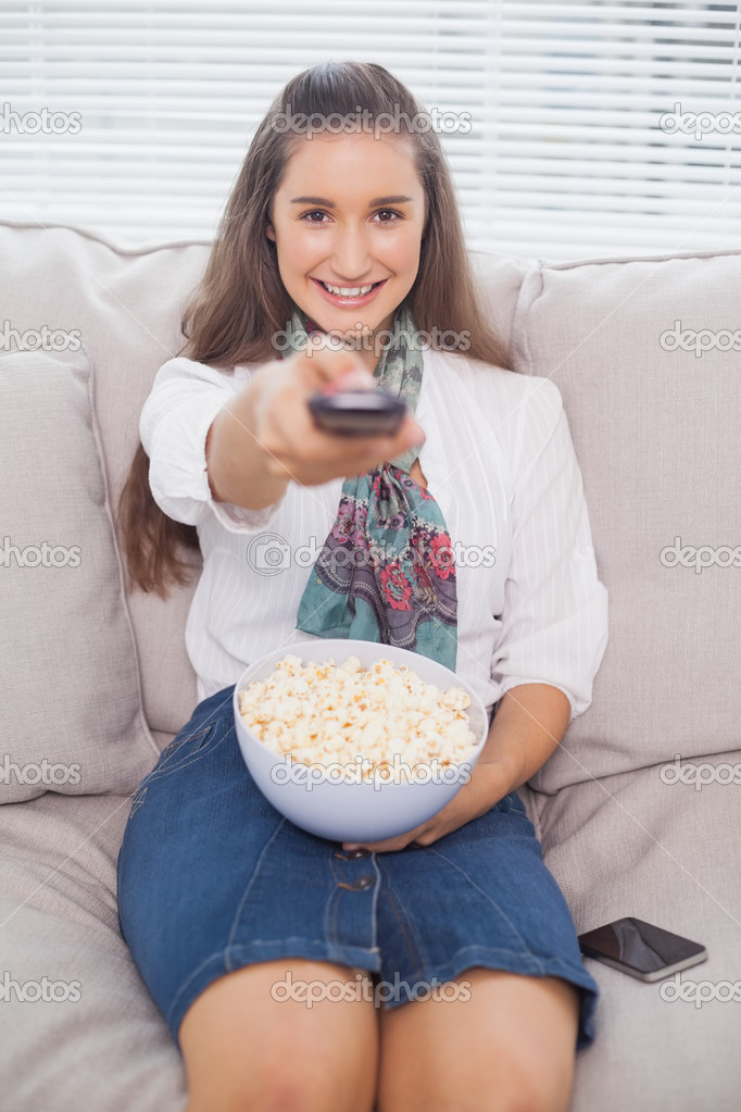Smiling cute model changing tv channel — Stock Photo © lightwavemedia ...