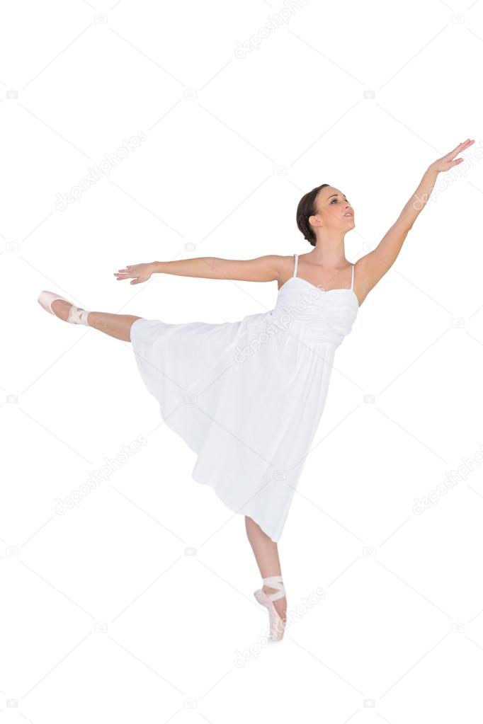 Focused ballet dancer posing on her tiptoe while rising a leg — Stock ...