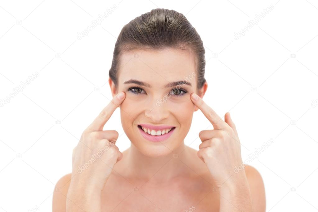 Smiling model pointing her eyes with her fingers — Stock Photo ...