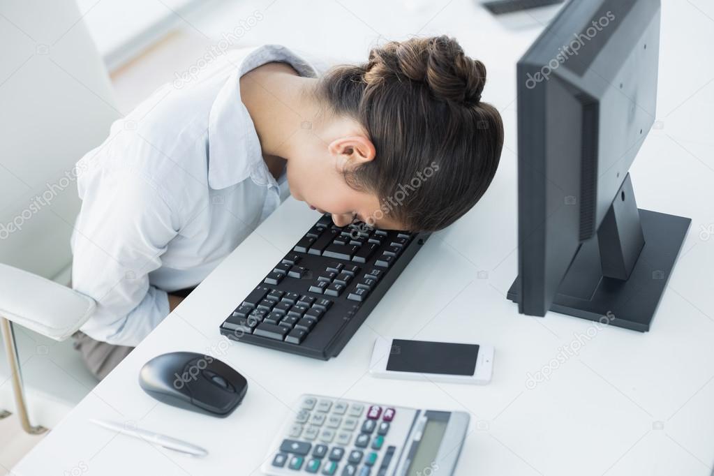 Businesswoman resting head on keyboard in office — Stock Photo ...