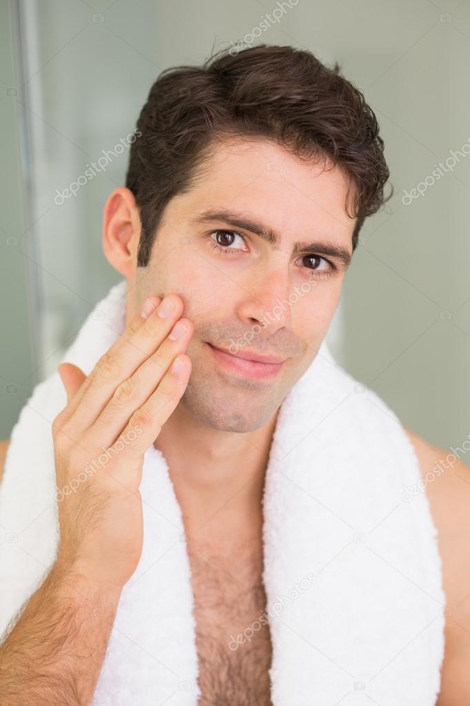 Handsome young man touching his face — Stock Photo © lightwavemedia ...
