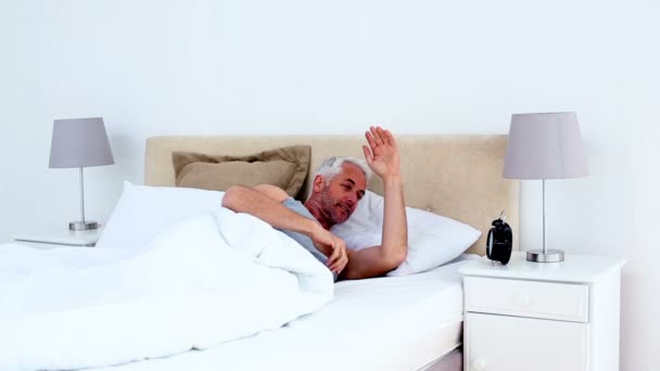 Groggy man waking up and looking at his alarm clock — Stock Video ...