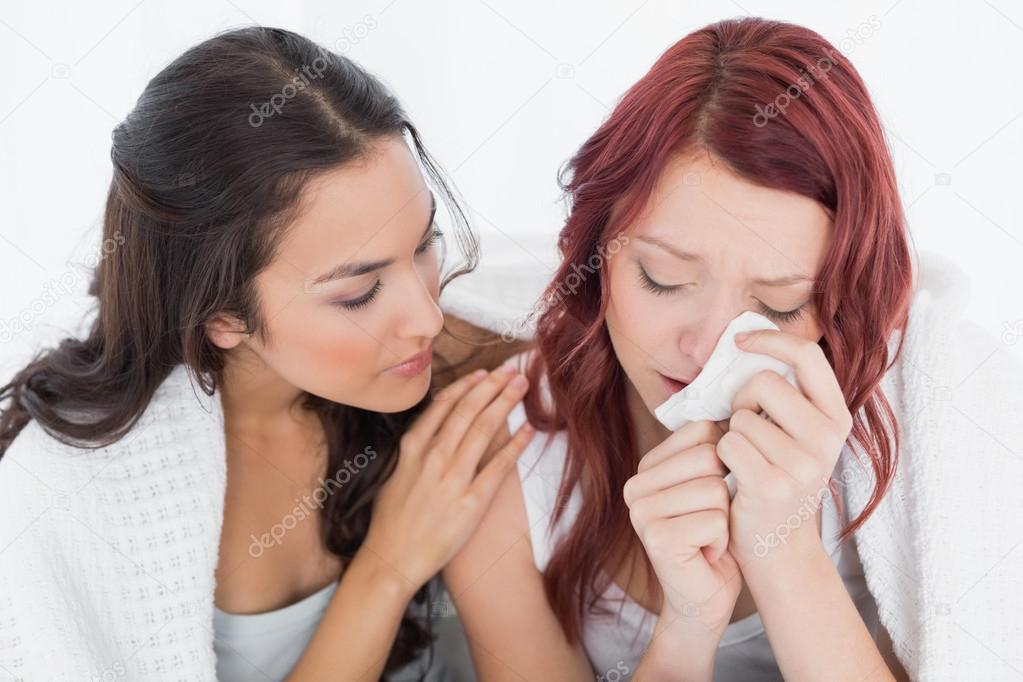 Young woman consoling a crying female friend Stock Photo by ...