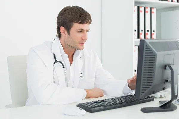 Male doctor using computer at medical office - Stock Image - Everypixel
