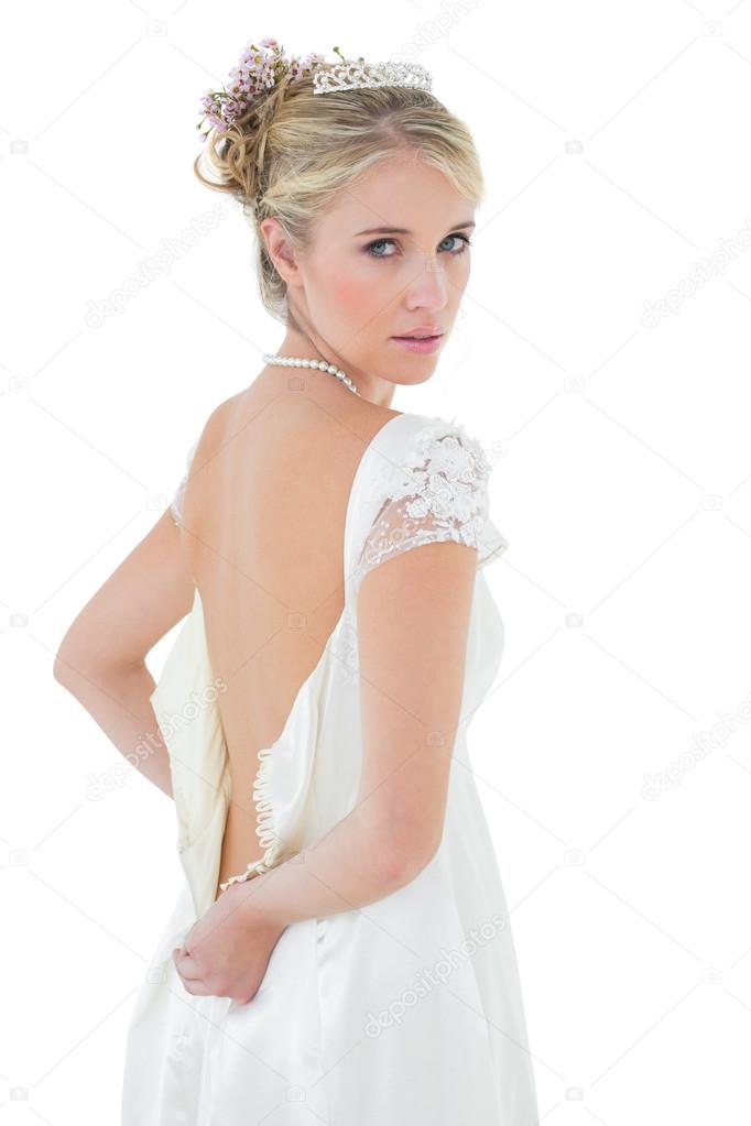 Beautiful bride getting dressed over white background — Stock Photo ...