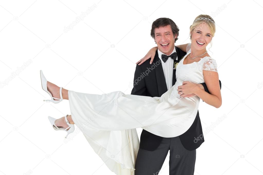 Happy groom carrying bride Stock Photo by ©lightwavemedia 42594809