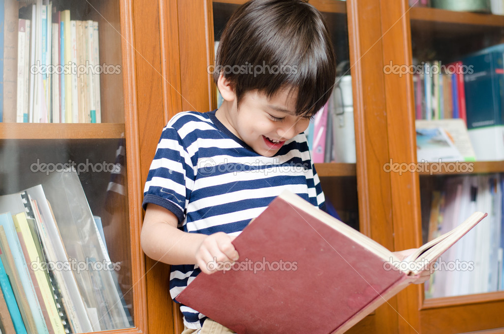 Little Boy in library holding book Stock Photo by ©wckiw 44024895
