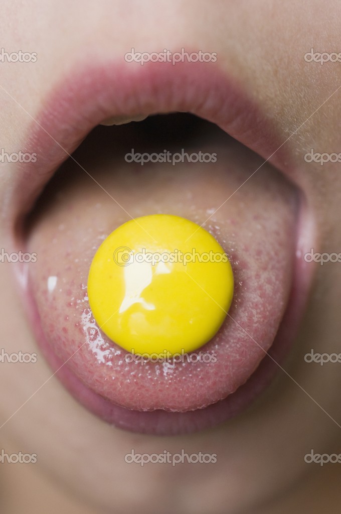 Mouth with candy on tongue Stock Photo by ©DesignPicsInc 31800229