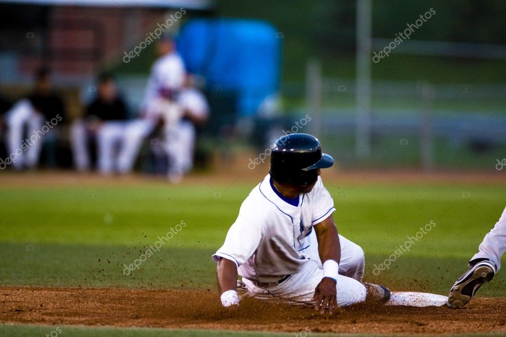 Baseball Player Sliding Onto A Base Stock Photo by ©DesignPicsInc 31800821