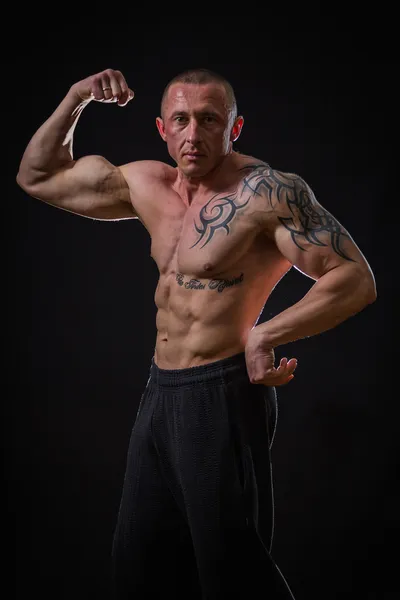 Muscle man in tattoos with dumbbells — Stock Photo © aallm #44346111