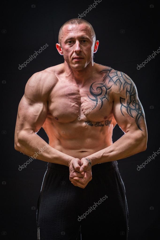 Muscle man with tattoos — Stock Photo © aallm #44345871