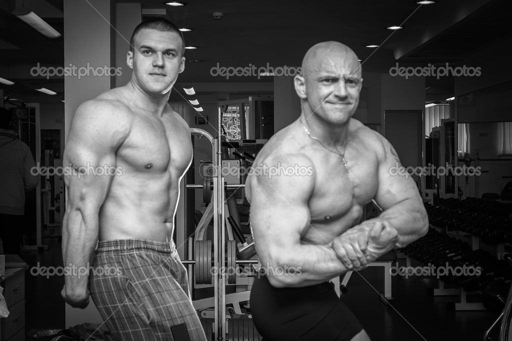 Two bodybuilders demonstrating muscles — Stock Photo © aallm #46870263