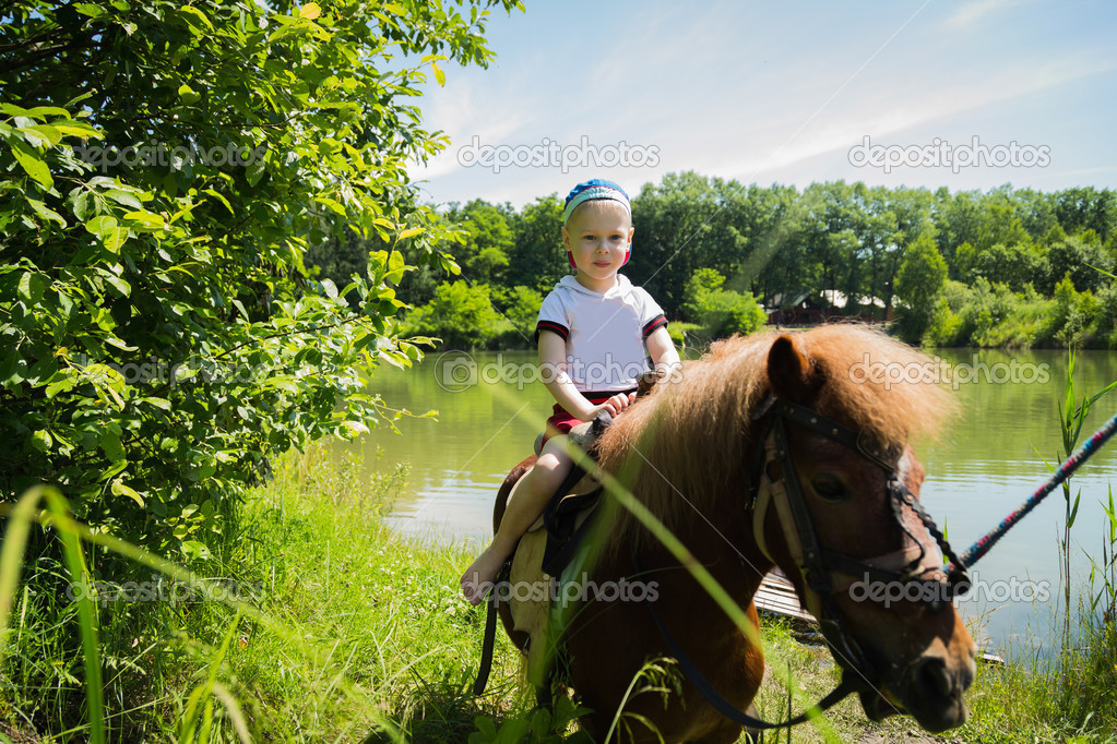 Boy riding pony Stock Photo by ©aallm 48819175