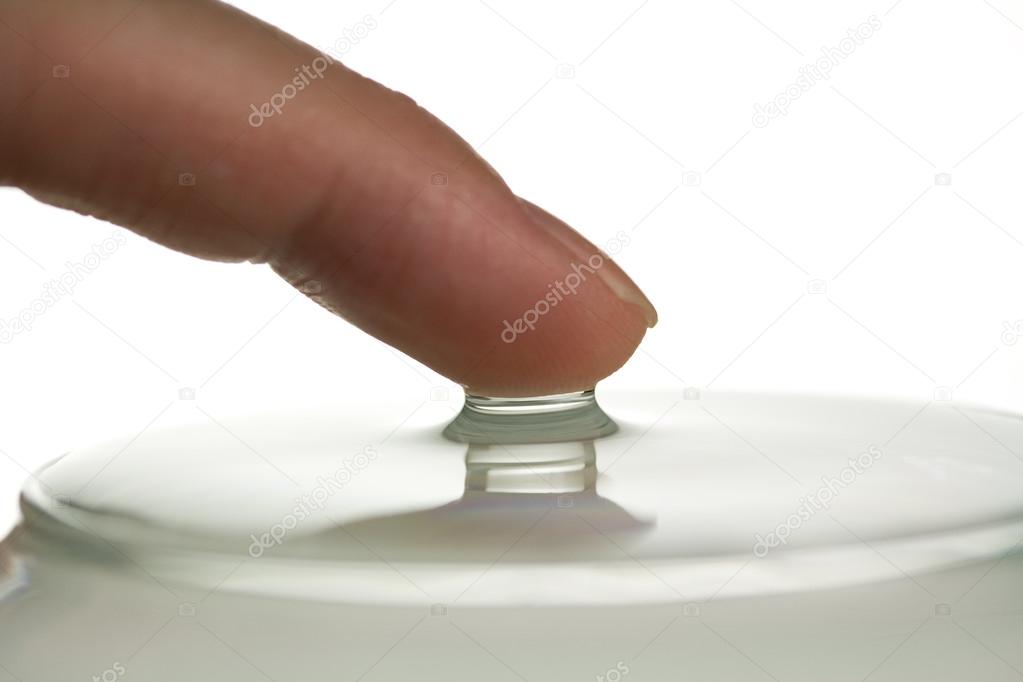 Finger Touching Surface of Water - Surface Tension Stock Photo by ...
