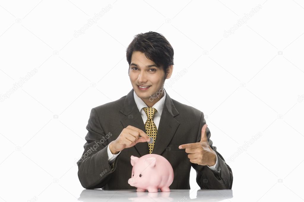 Businessman pointing towards a piggy bank — Stock Photo © imagedb ...
