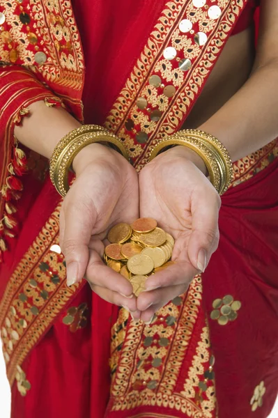Woman holding gold coins - Stock Image - Everypixel